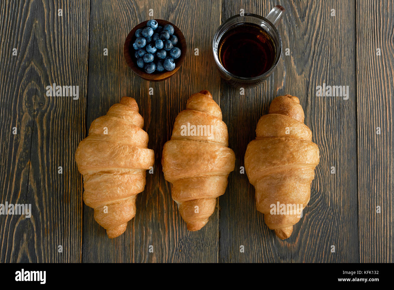 Freshly baked croissants on wooden table Stock Photo - Alamy