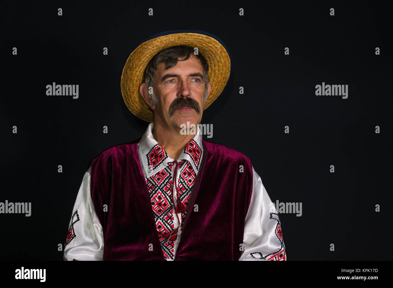 Low key portrait of mature Ukrainian country-man in traditional clothes ...