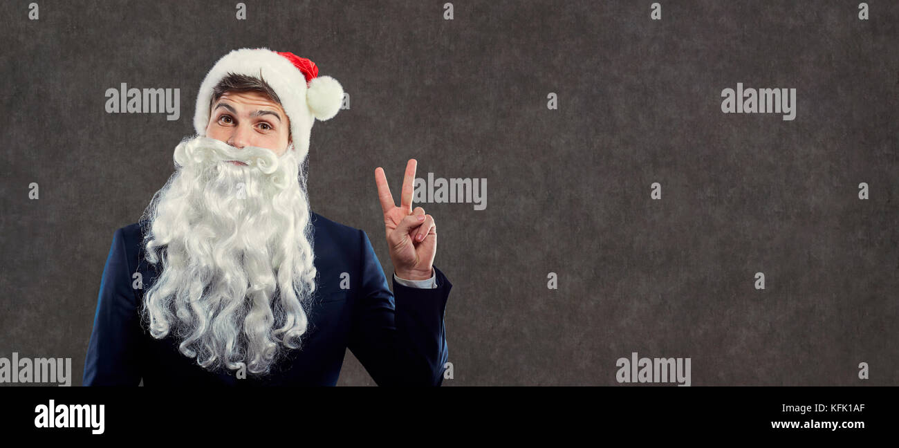 Santa Claus in business suit showing thumbs up symbol of victory Stock ...