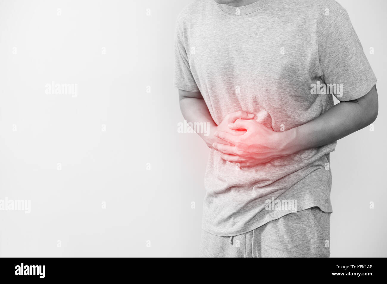 a man pressing his stomach, with red highlight of stomach pain and ...
