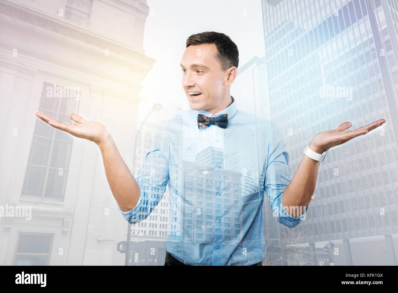 Joyful nice man looking at his hands Stock Photo - Alamy