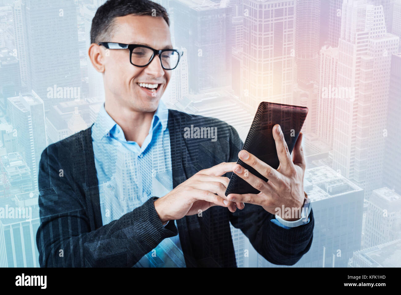 Cheerful nice man using a tablet Stock Photo - Alamy
