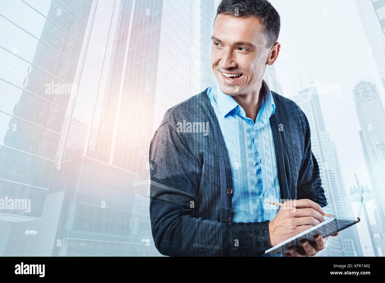 Cheerful delighted nice man looking aside Stock Photo - Alamy