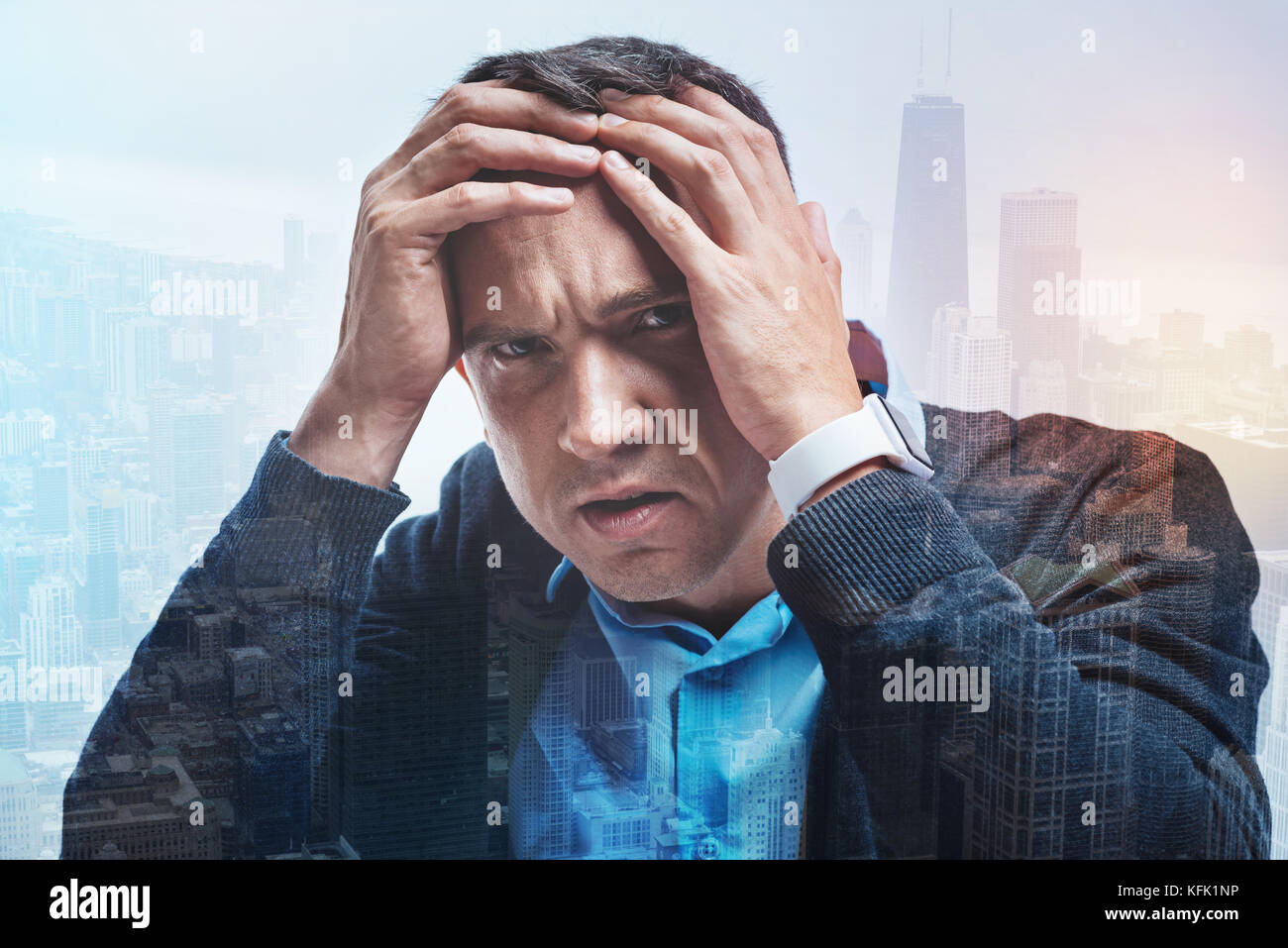 Serious unhappy man holding his head Stock Photo - Alamy