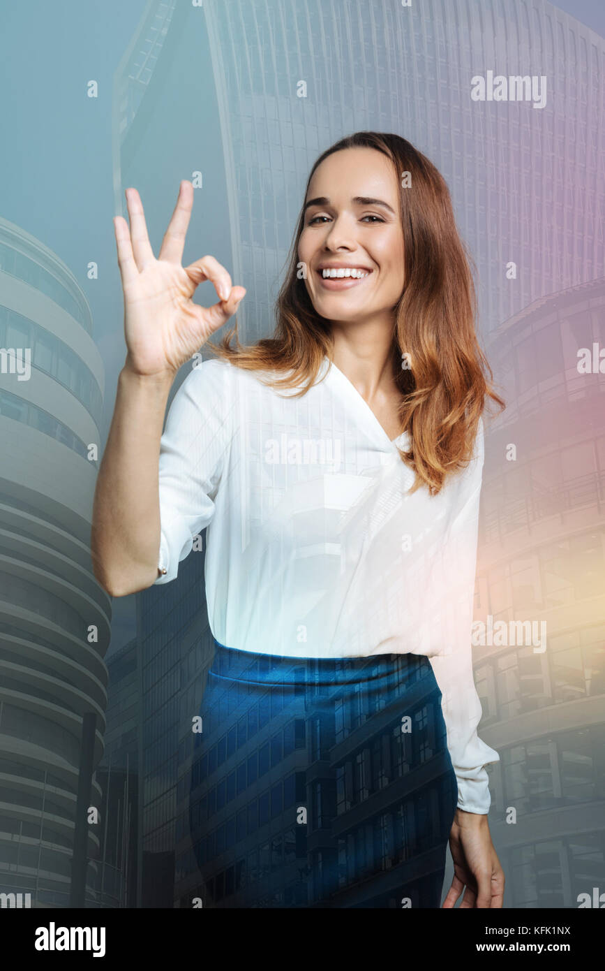 Happy delighted woman showing OK gesture Stock Photo - Alamy