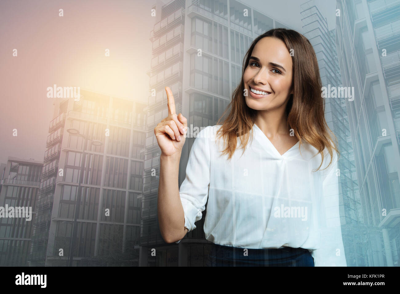 Happy cheerful woman pointing with her finger Stock Photo - Alamy