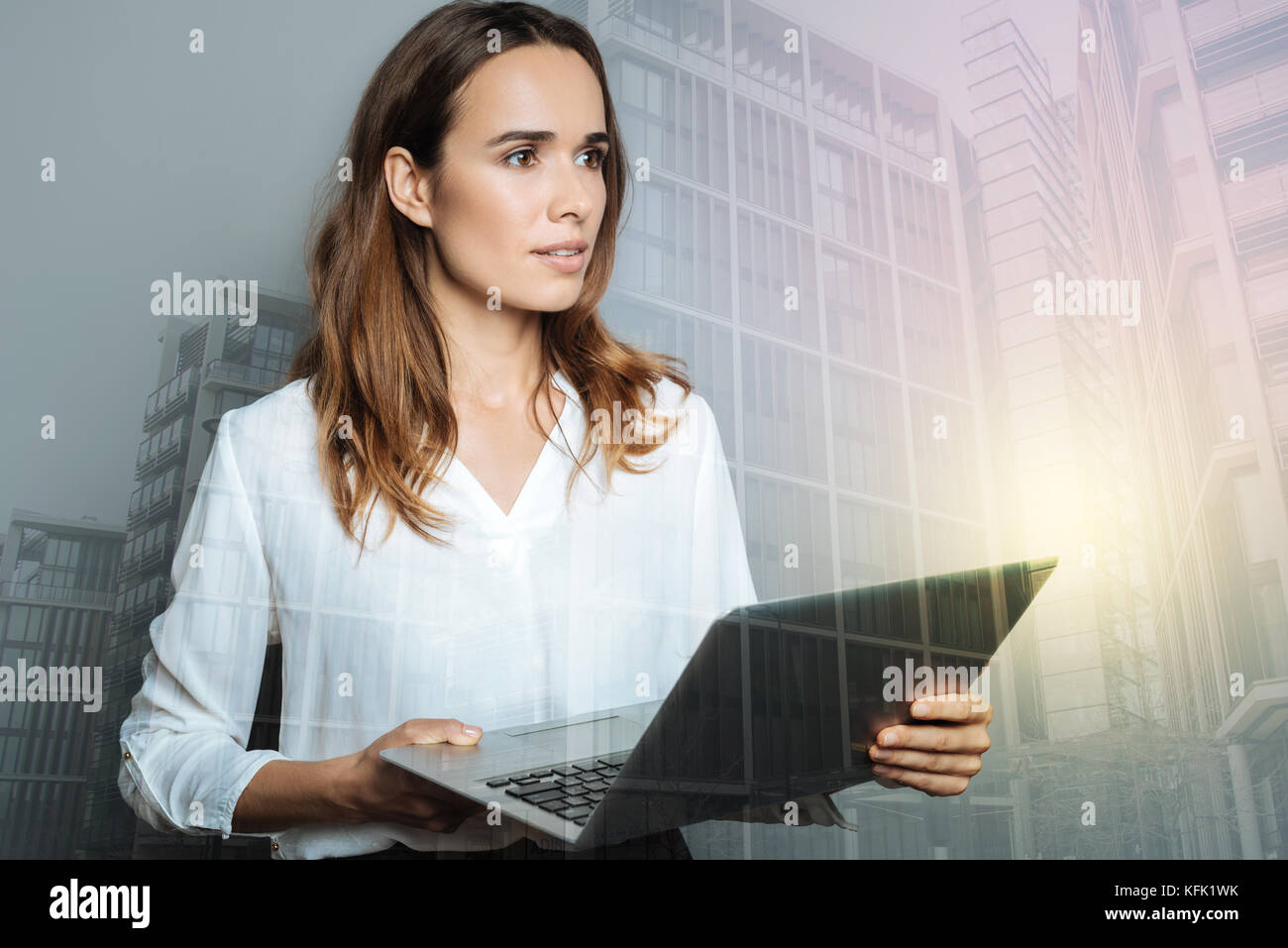Pleasant smart woman working on a laptop Stock Photo - Alamy