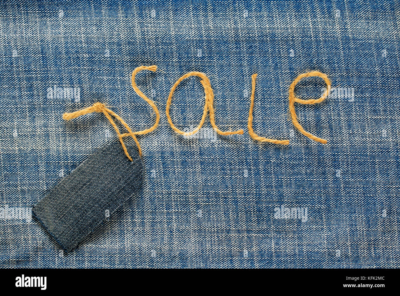 stylish denim fabric background with the inscription sale of twine in ...
