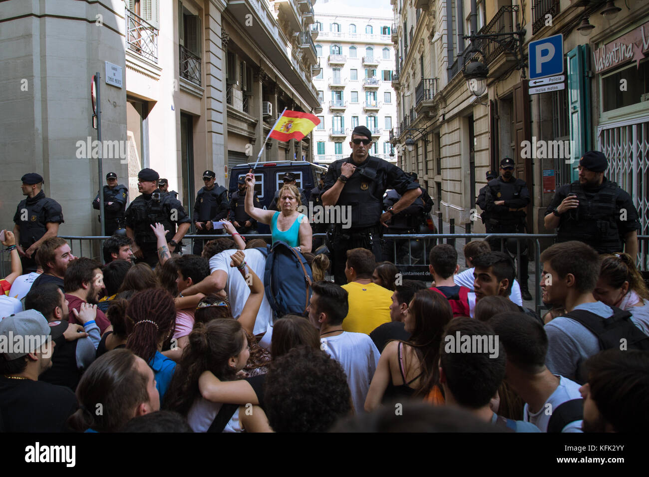 A woman stands up with a spanish flag taking a stand with the police ...