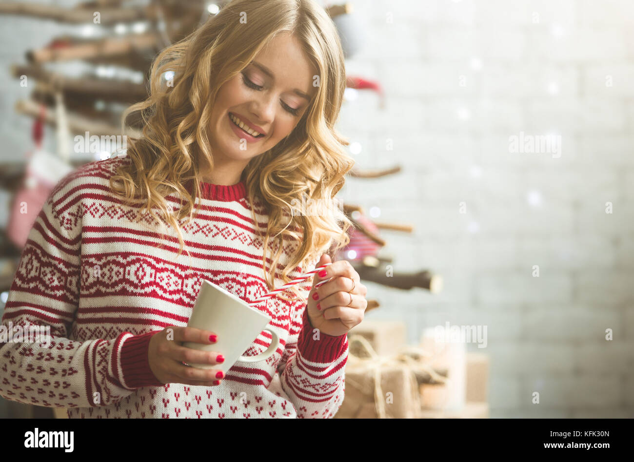 Young beautiful woman drinking cup of coffee blurred winter snow tree ...