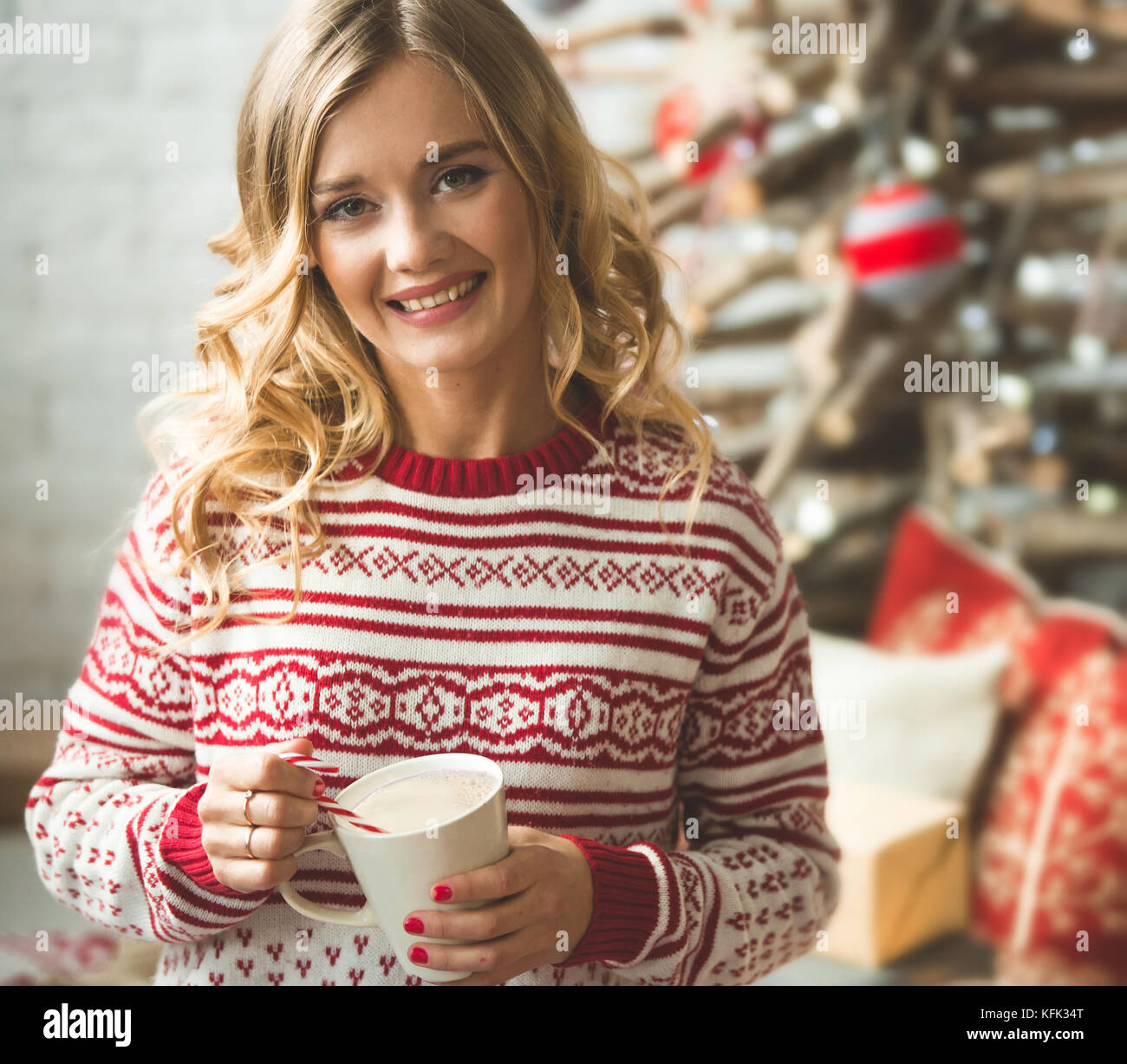 Young beautiful woman drinking cup of coffee blurred winter snow tree ...