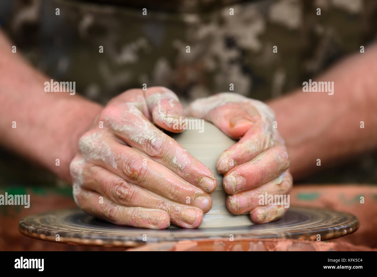 Hands of a potter. Potter making ceramic pot on the pottery wheel Stock ...