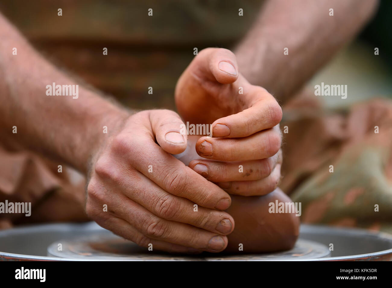 Hands of a potter. Potter making ceramic pot on the pottery wheel Stock ...