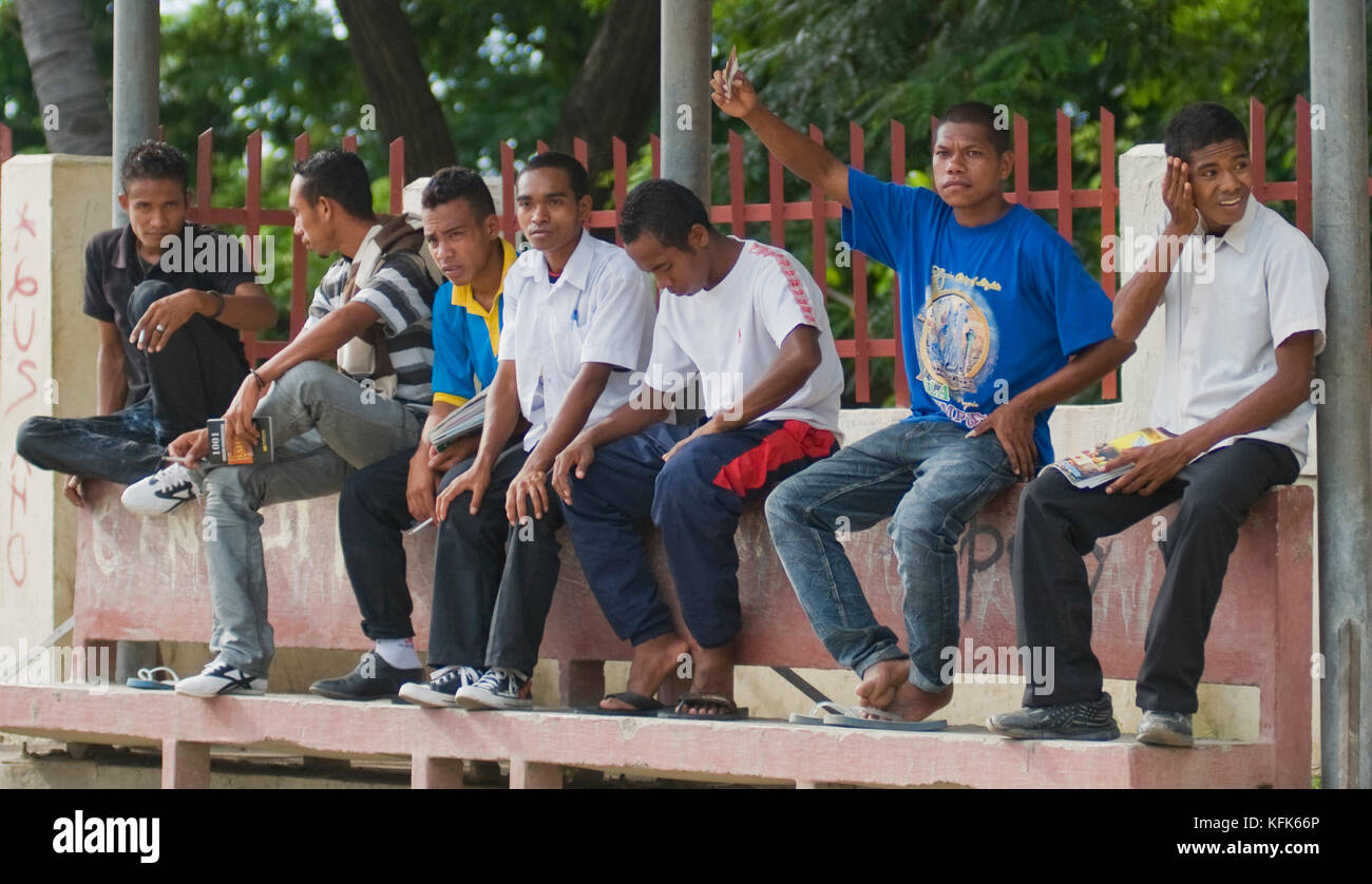 Young men sit on a bench in Dili, Timor-Leste (East Timor Stock Photo ...