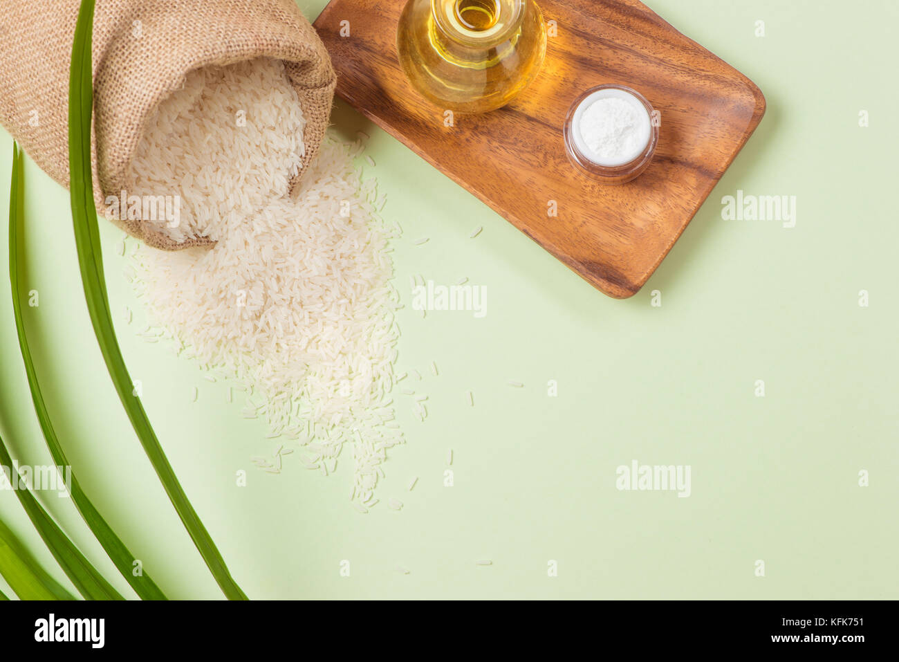 Rice oil in bottle glass and milk over green background Stock Photo - Alamy
