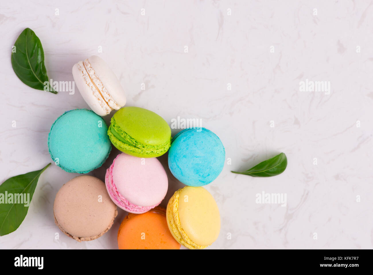 Sweet colorful macarons on marble stone background with copy space ...
