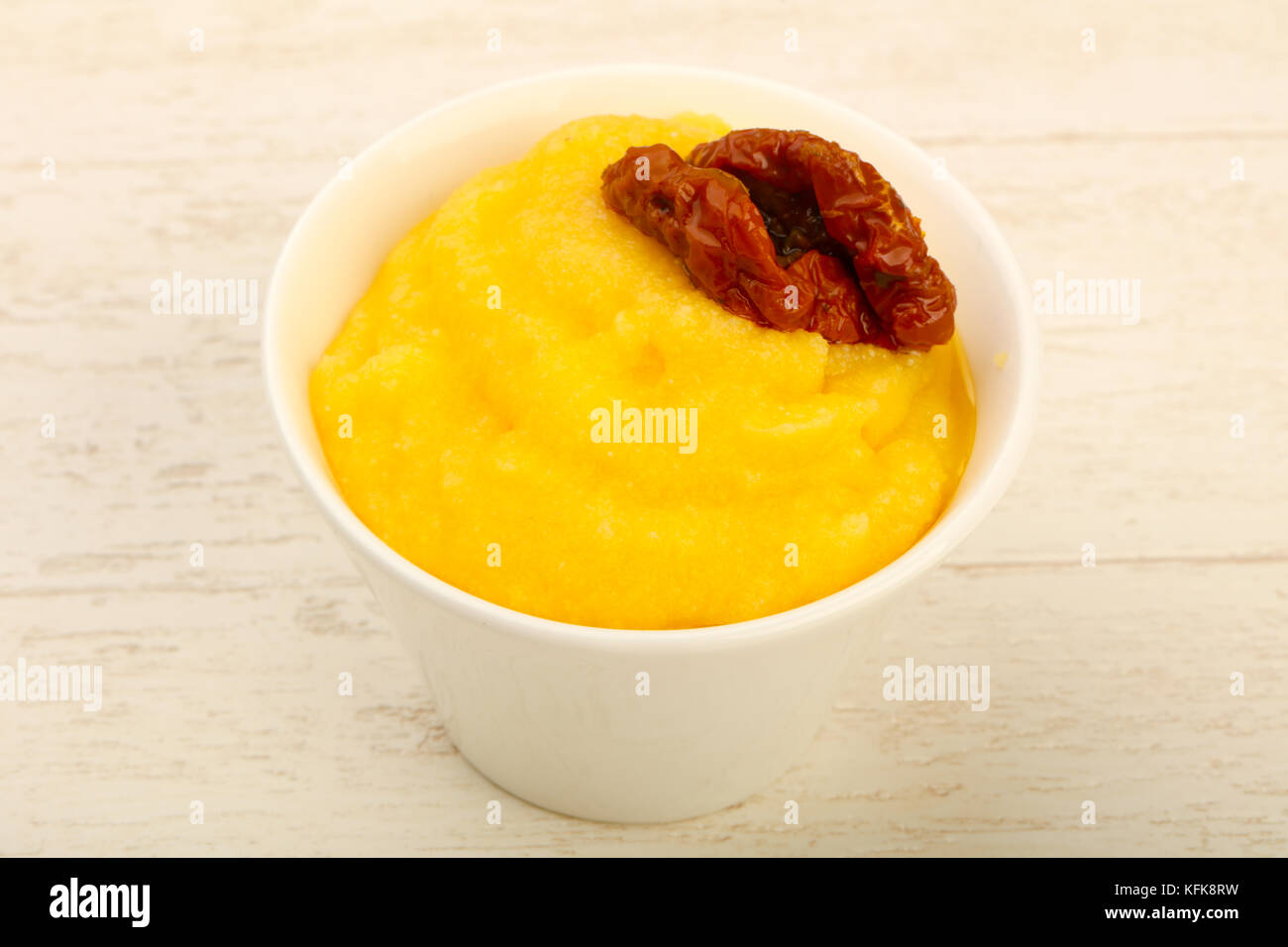 Polenta with dry tomato Stock Photo - Alamy