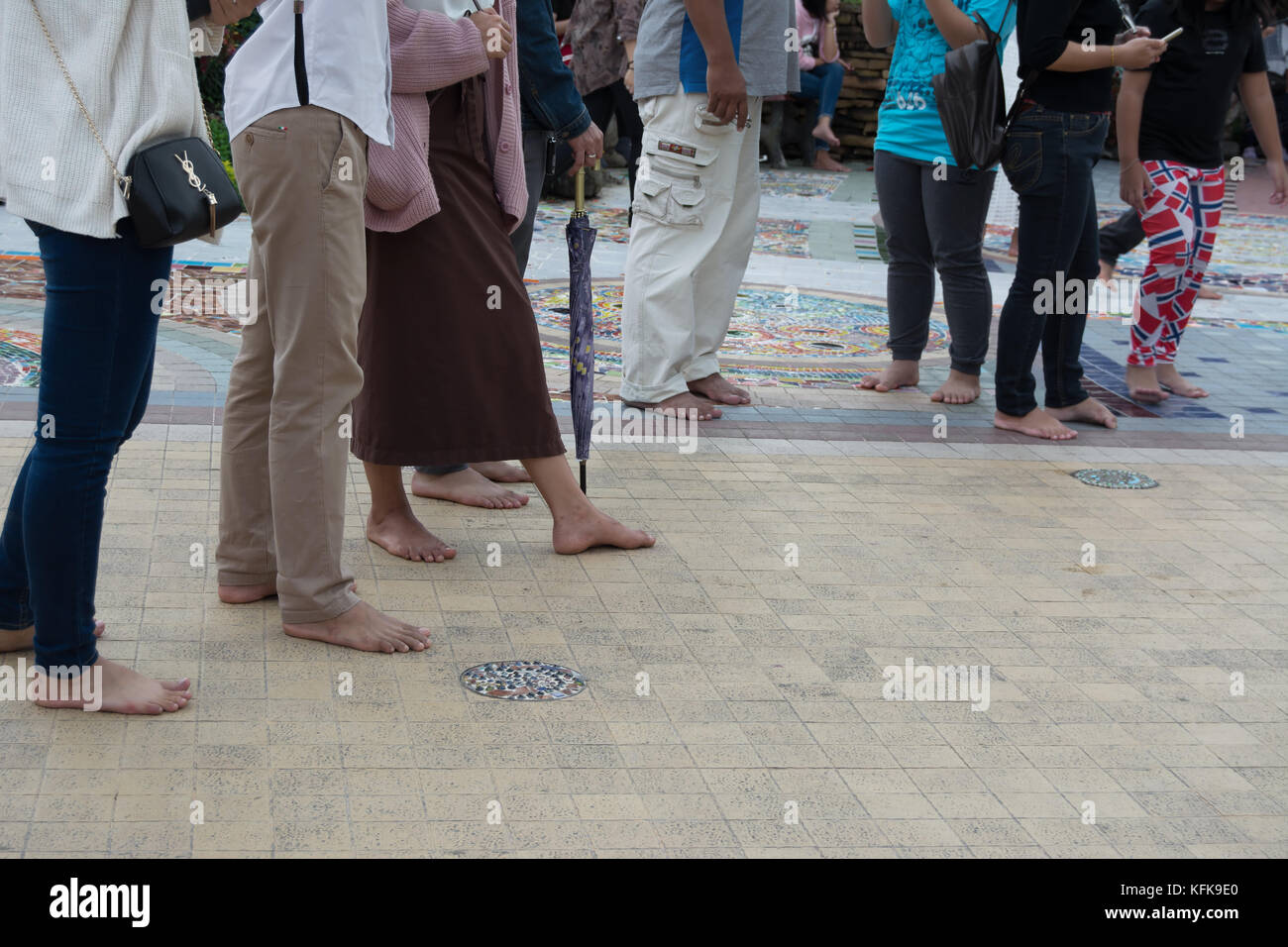 barefooted visitors to the temple, wat phra that pha kaew, in khao kho ...
