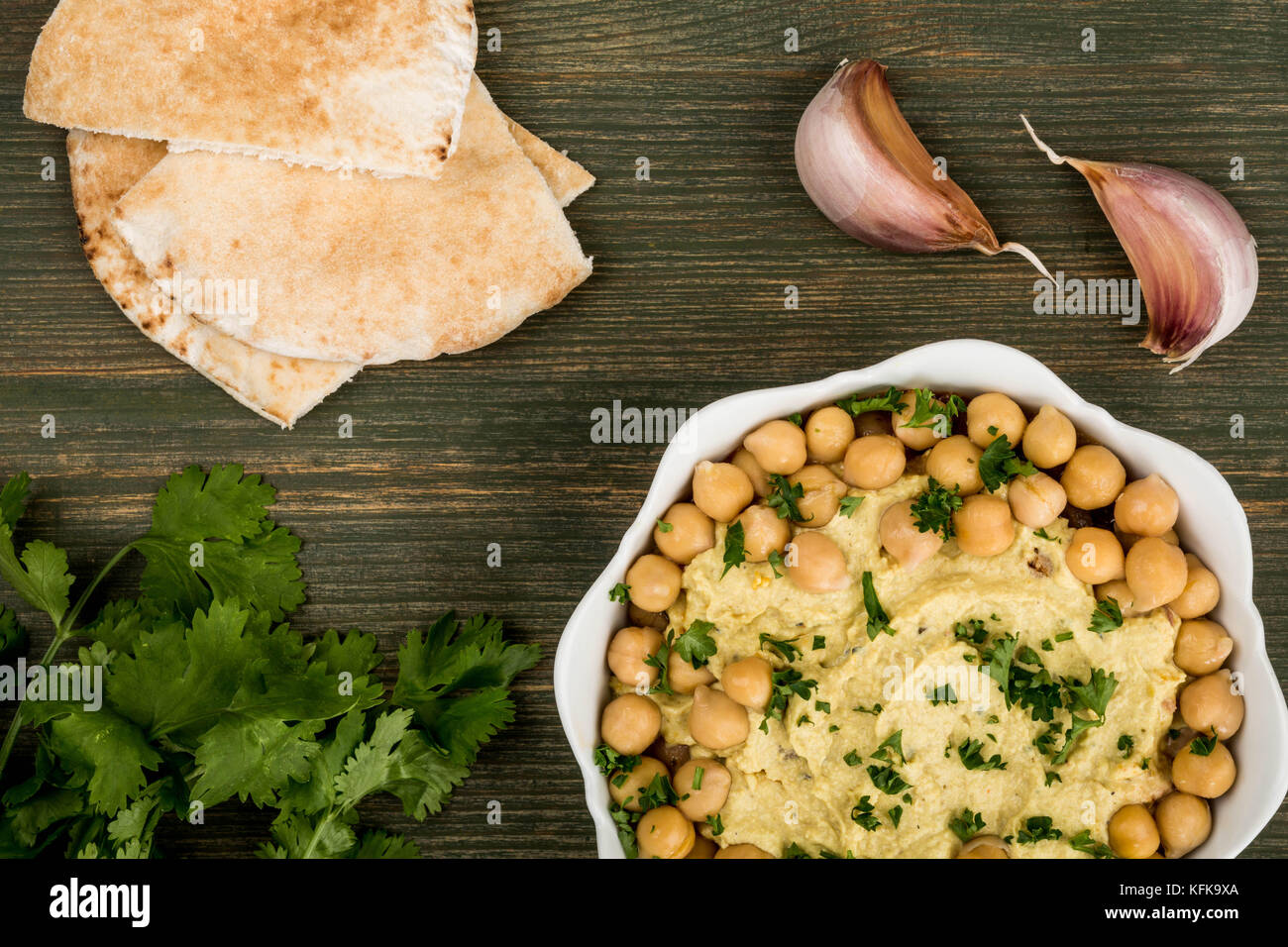 Hummus With Chickpeas and Pitta Bread On A Green Wooden Background With ...