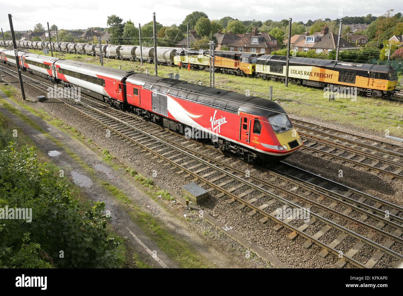 Virgin Trains East Coast high speed train passing Colas Rail Freight ...