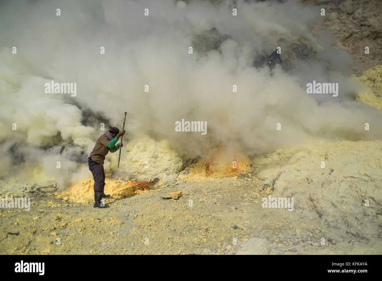 A miner extracting sulfur from the Kawah Ijen Volcano crater, East Java ...