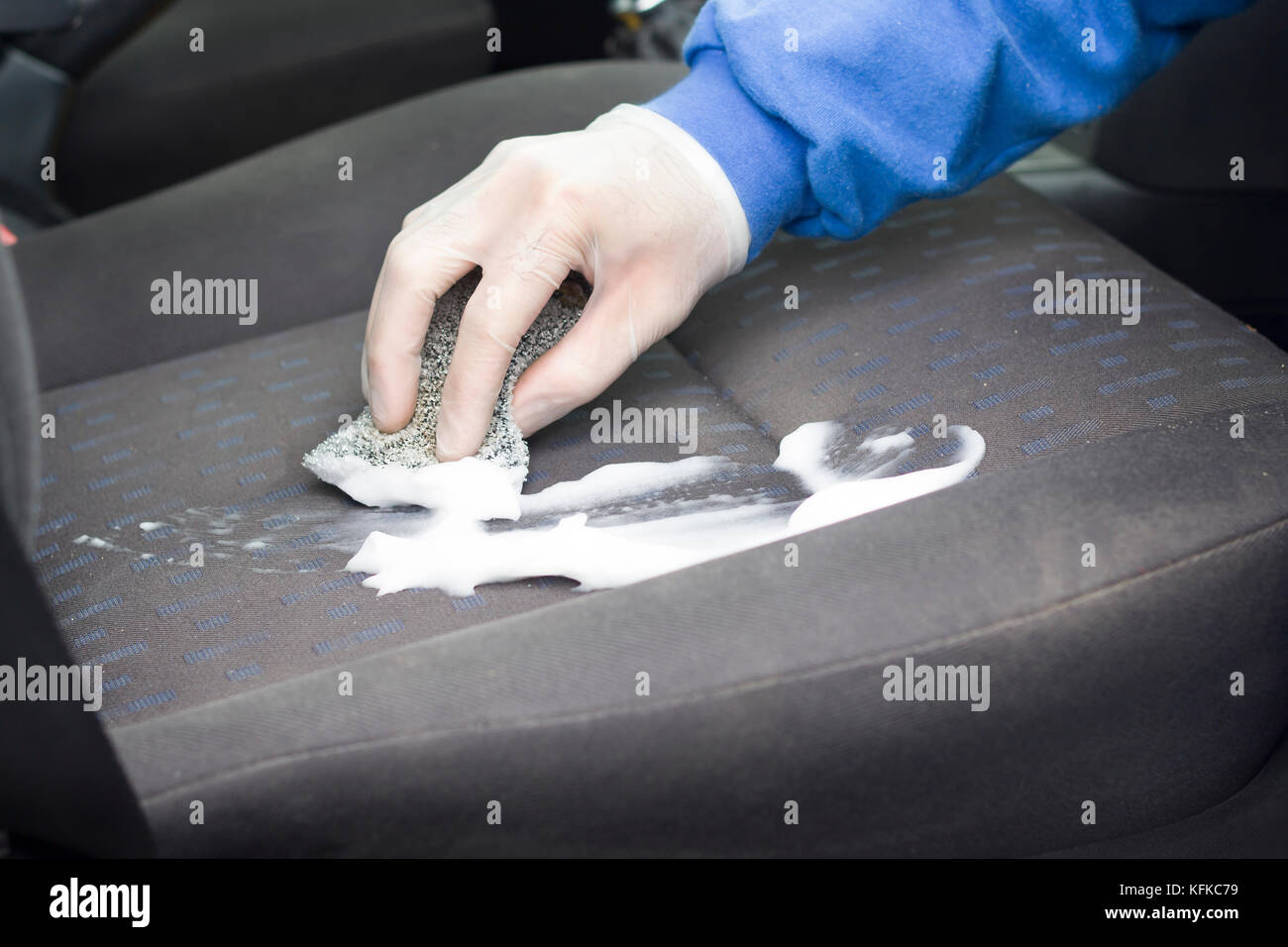 Hand wash car upholstery with washing foam and sponge Stock Photo - Alamy