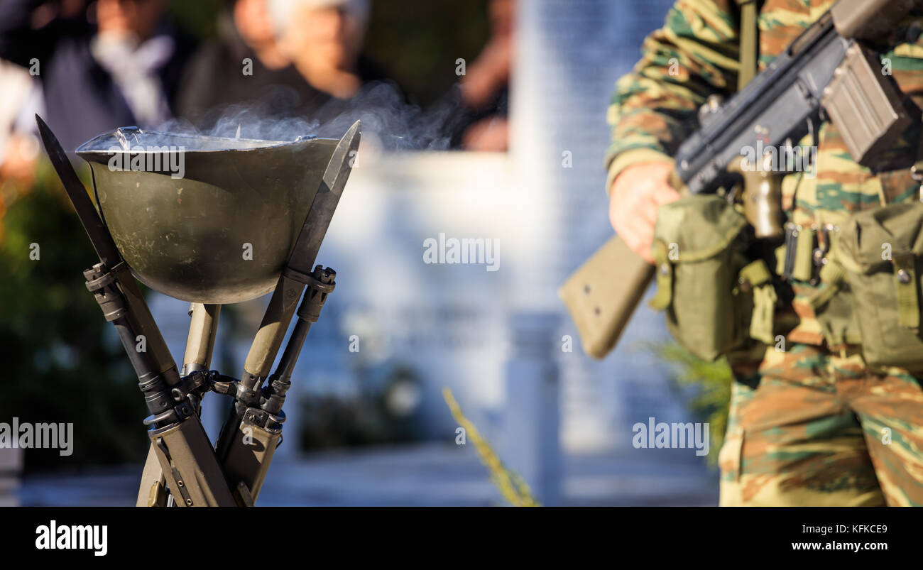 Fire in a soldier helmet and a soldier holding a weapon during a ...