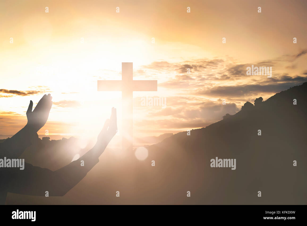 Human hands raising hand while praying to jesus on sunset background ...