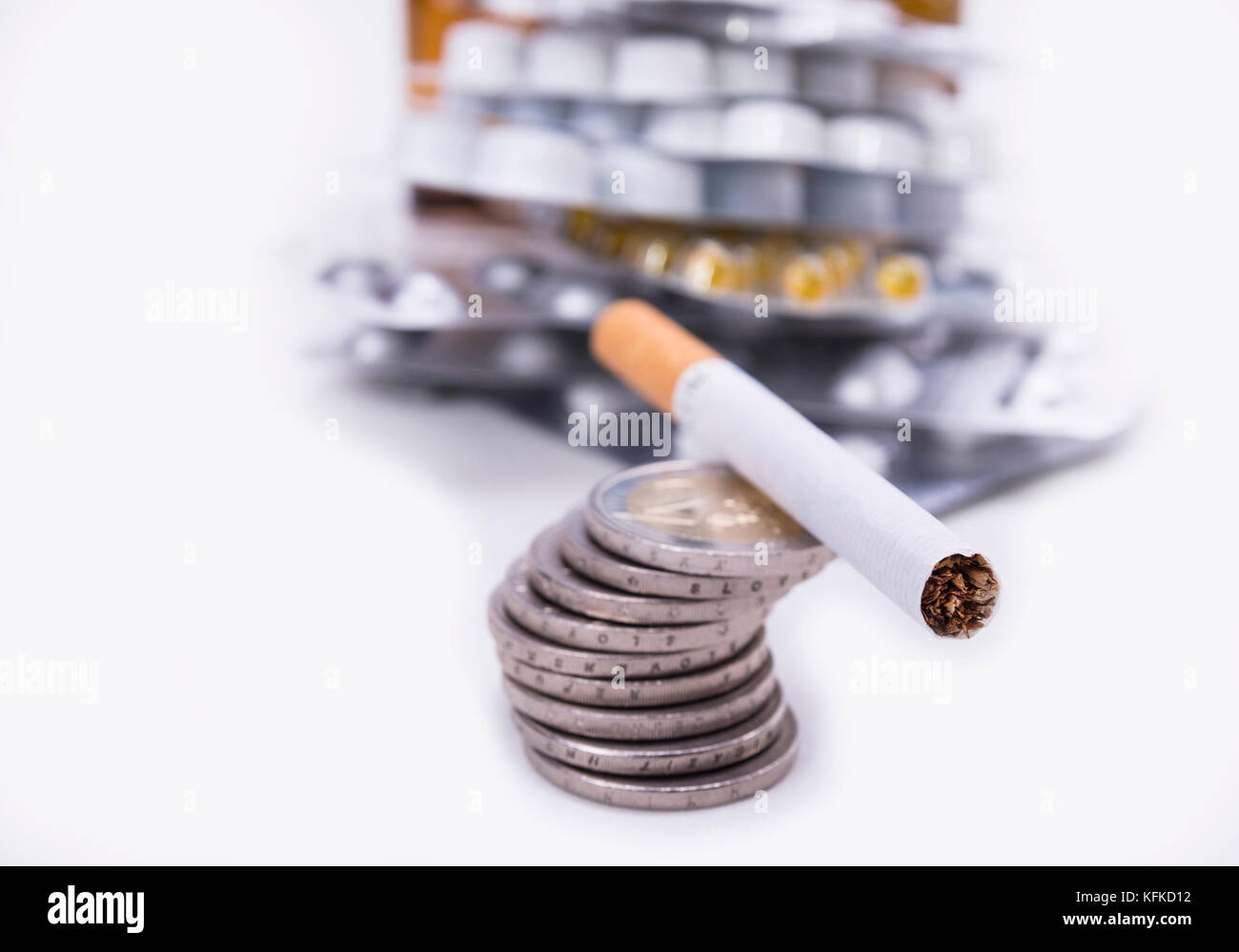 Cigarette on the euro coins. Smoking costs money and is harmful Stock ...