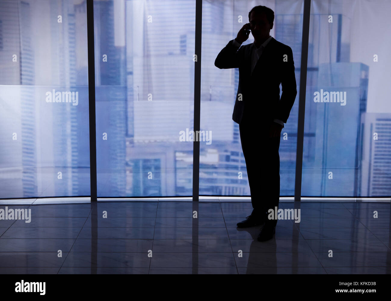 full-length-of-businessman-using-cell-phone-in-office-stock-photo-alamy