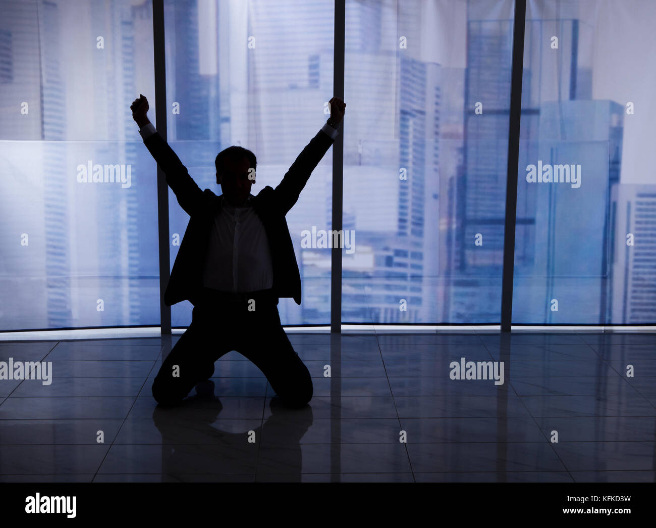 Full length rear view of businessman sitting arms outstretched by ...