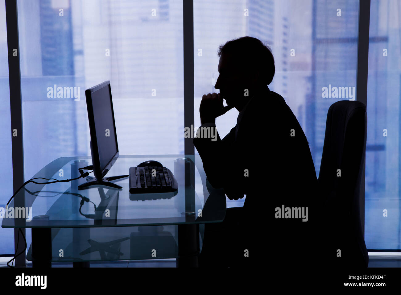 Side view of businessman using computer in office Stock Photo - Alamy
