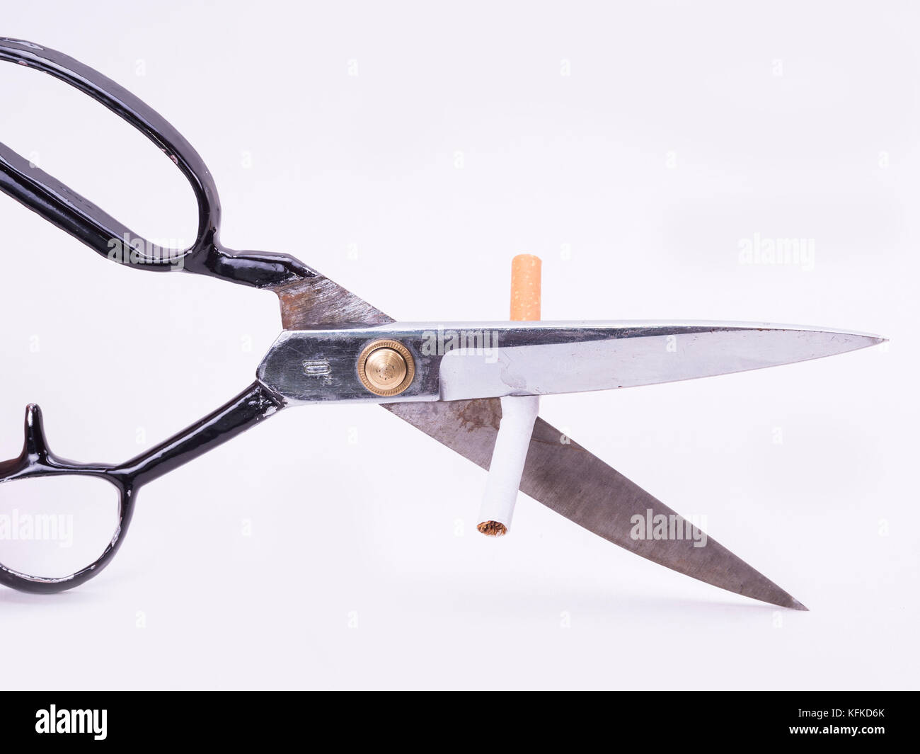 Big scissors are use to cut cigarette to quit smoking Stock Photo - Alamy