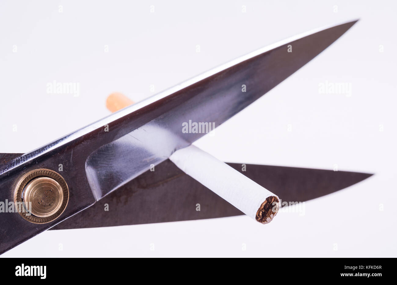Cut cigarette with scissers and stop smoking to save your health and ...