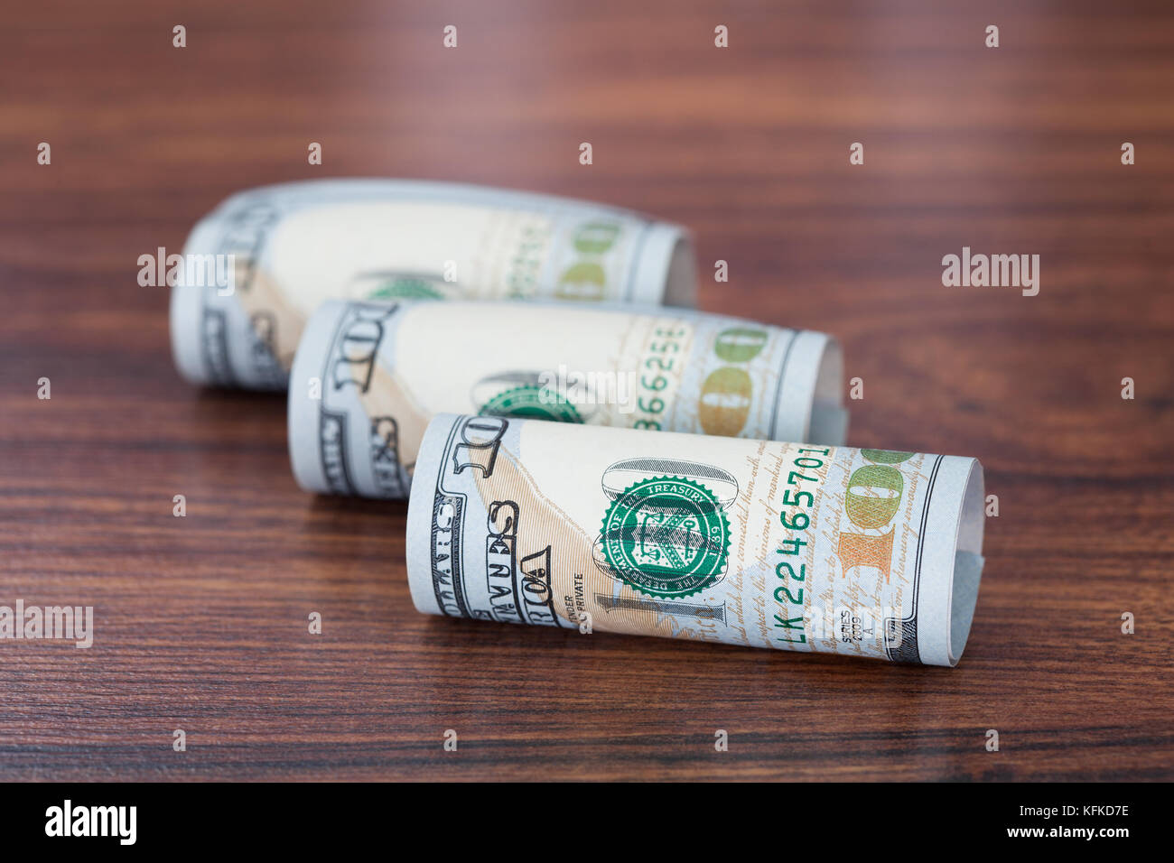 Closeup of rolled American banknotes on table Stock Photo - Alamy
