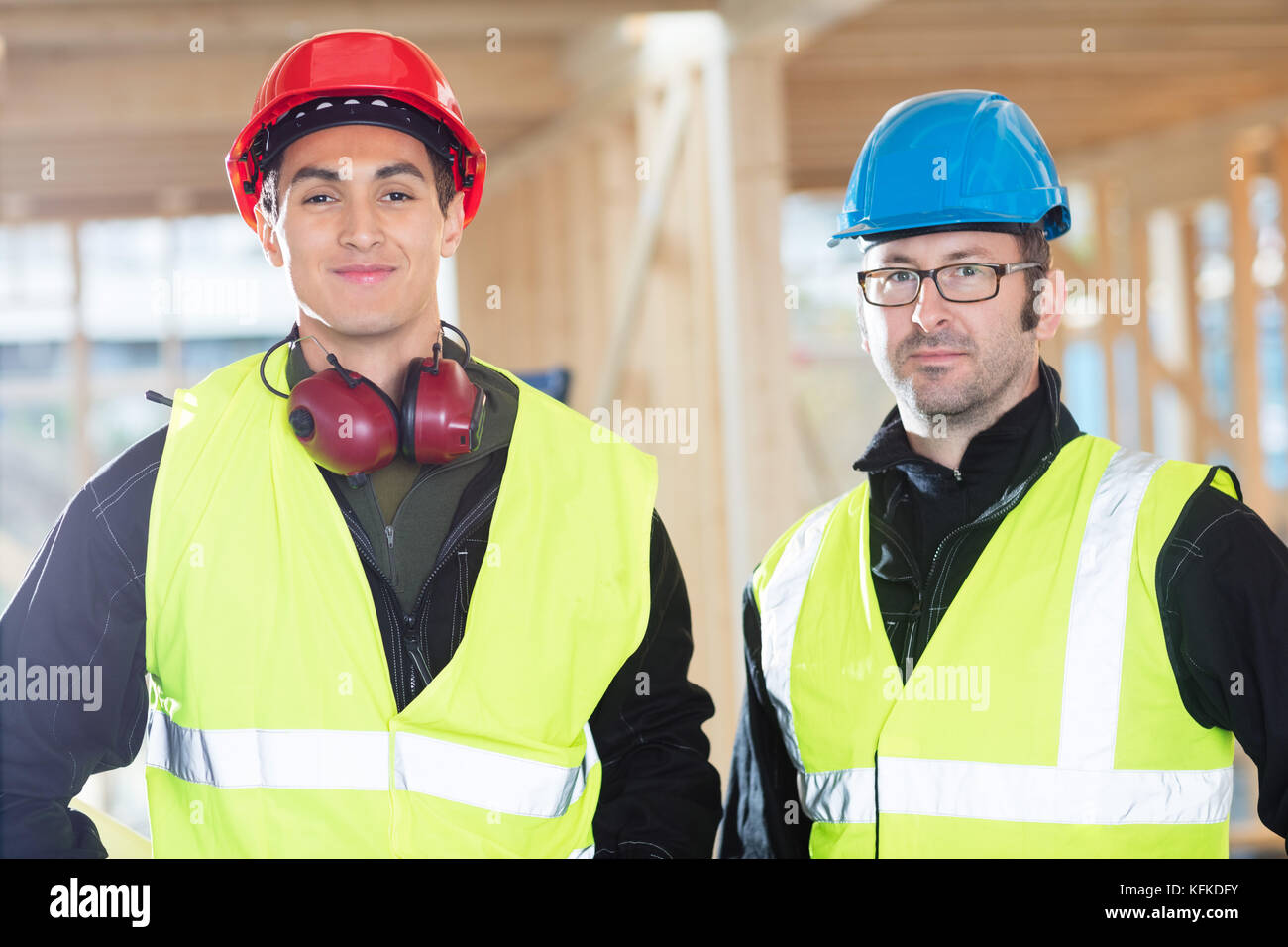 Confident Carpenters In Protective Clothing At Construction Site Stock ...
