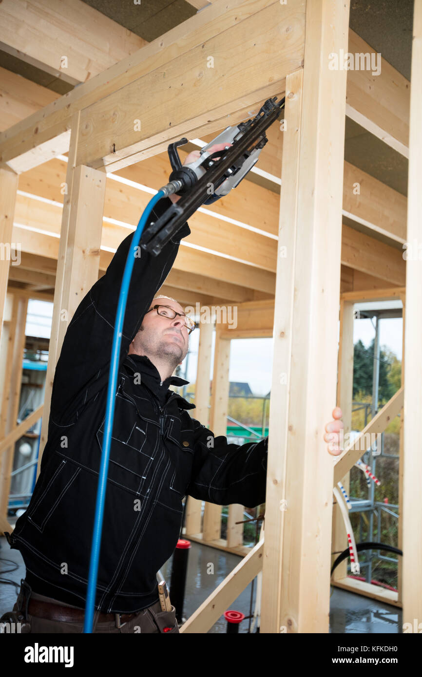 Carpenter Drilling Corner Of Wood At Site Stock Photo - Alamy