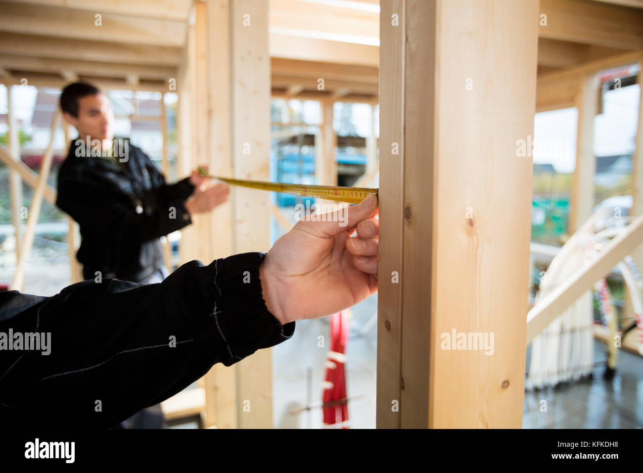 Cropped Image Of Carpenter Measuring Wood With Help Of Colleague Stock ...