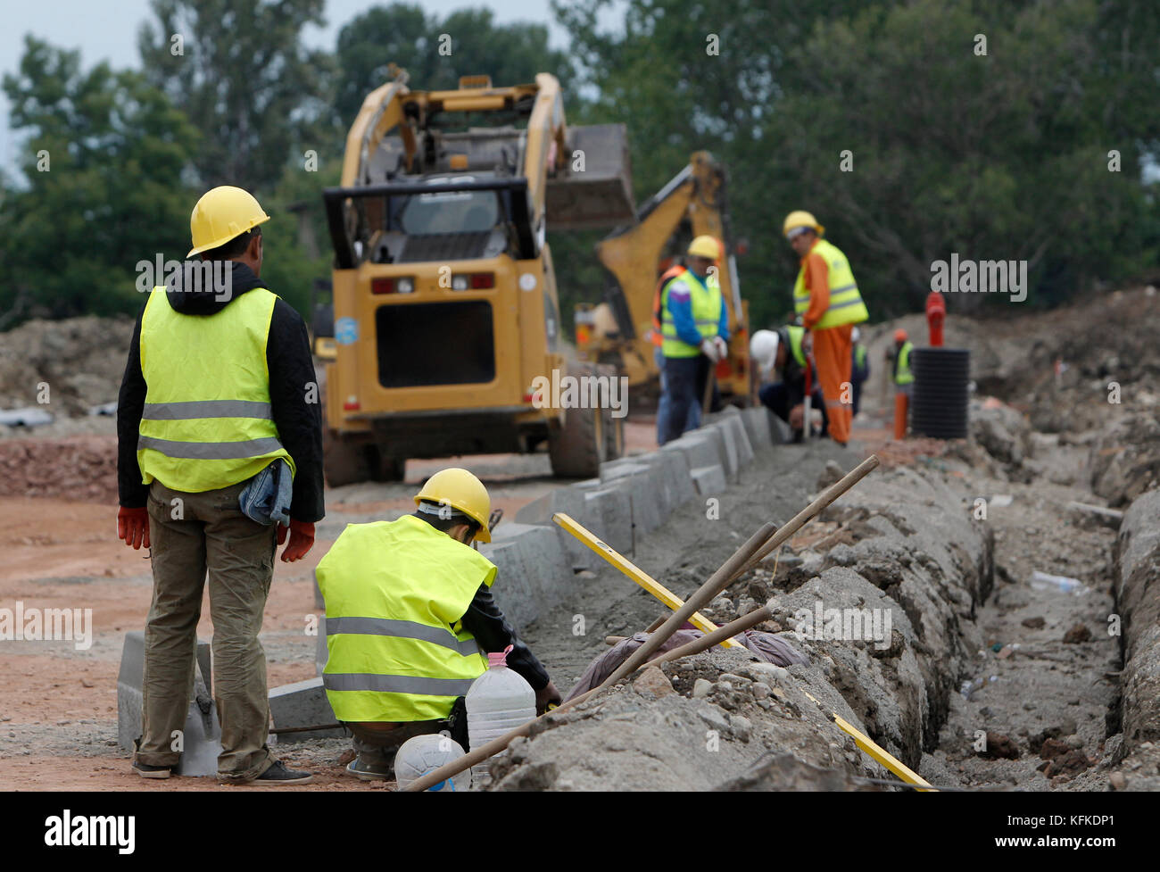 Laborers work at a road construction site Stock Photo - Alamy