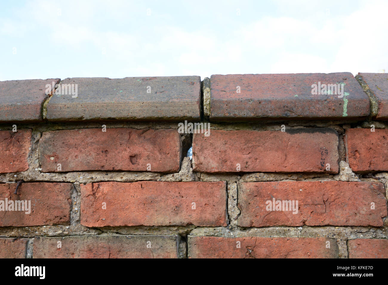 Brick wall in garden with bricks and mortar decaying diue to weathering ...