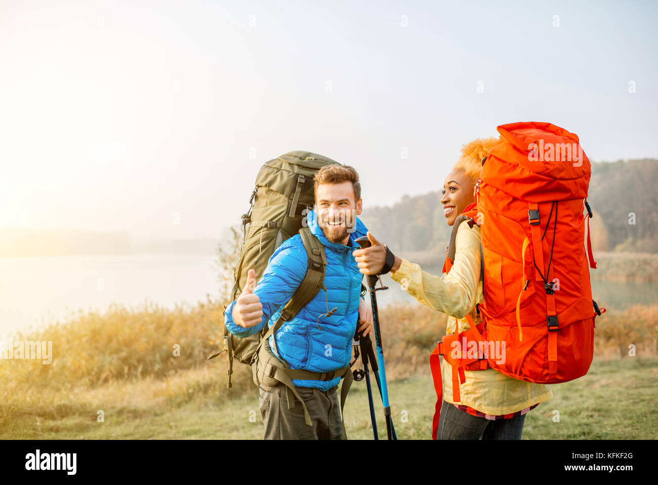 Couple hiking with backpacks Stock Photo - Alamy