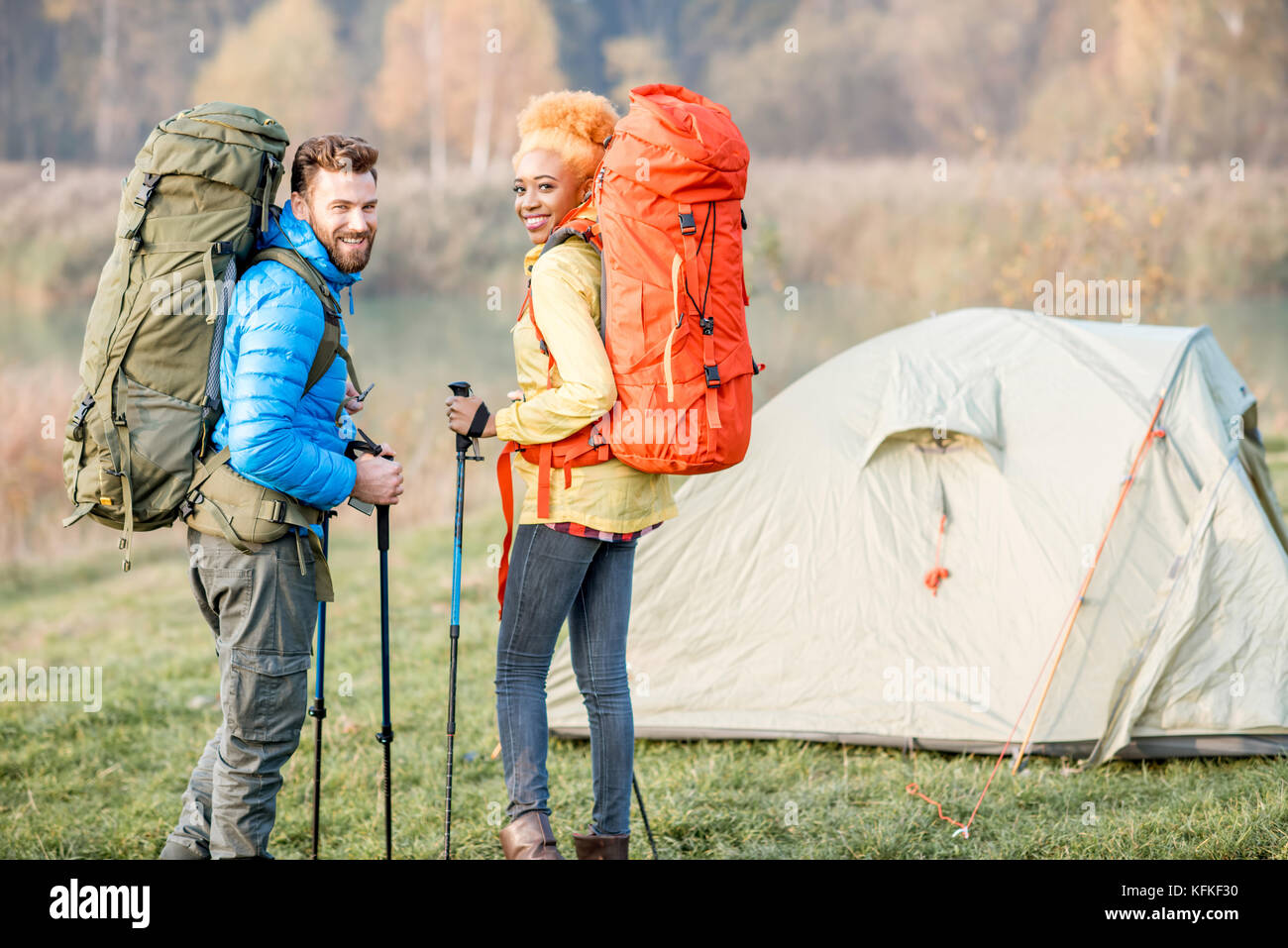 Couple hiking with backpacks Stock Photo - Alamy