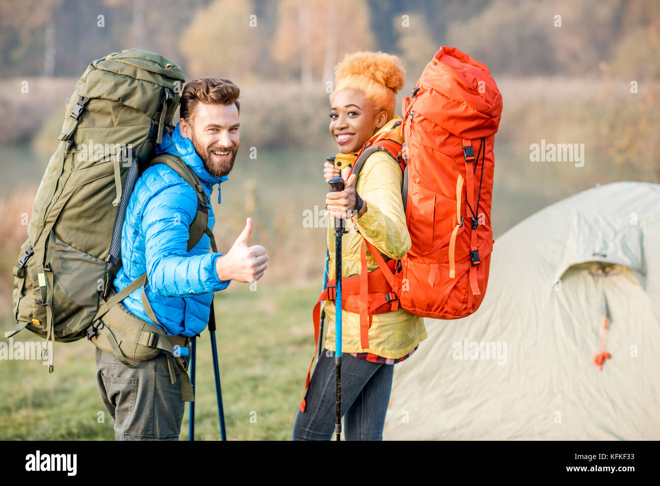 Couple hiking with backpacks Stock Photo - Alamy
