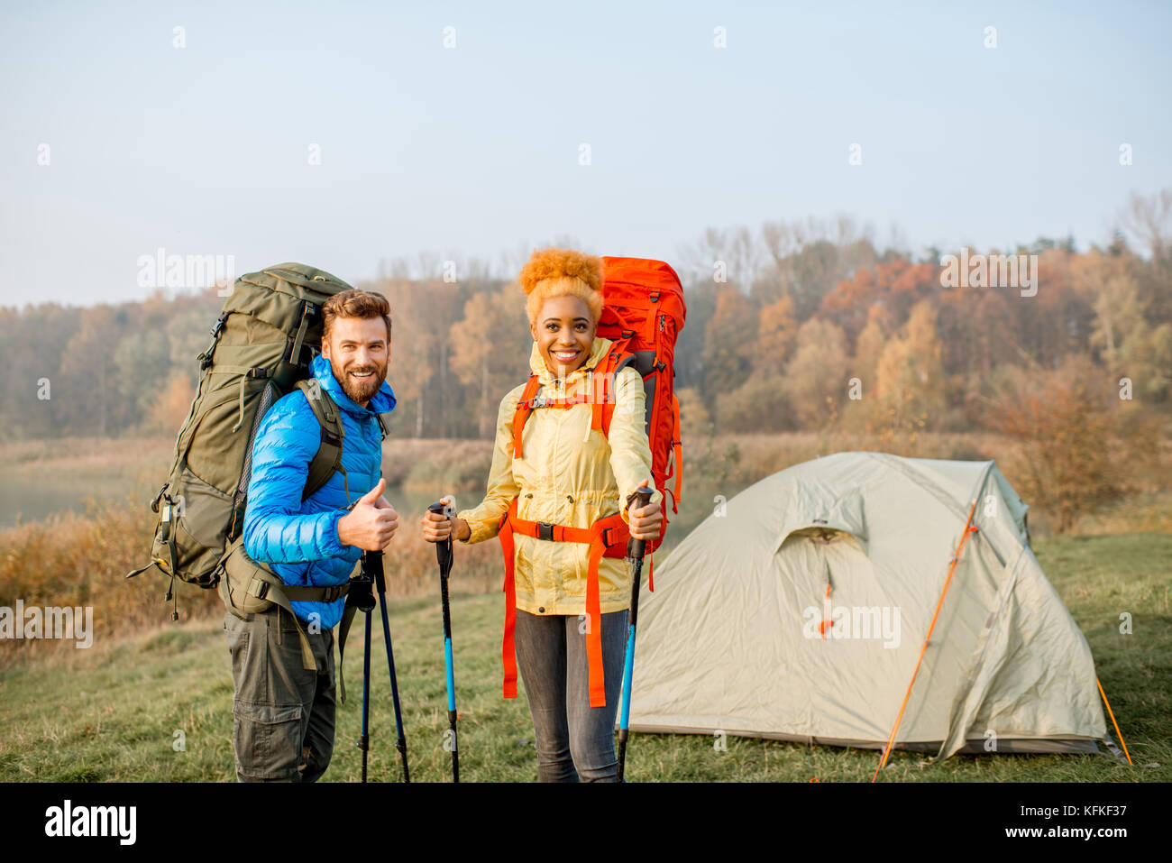 Couple hiking with backpacks Stock Photo - Alamy