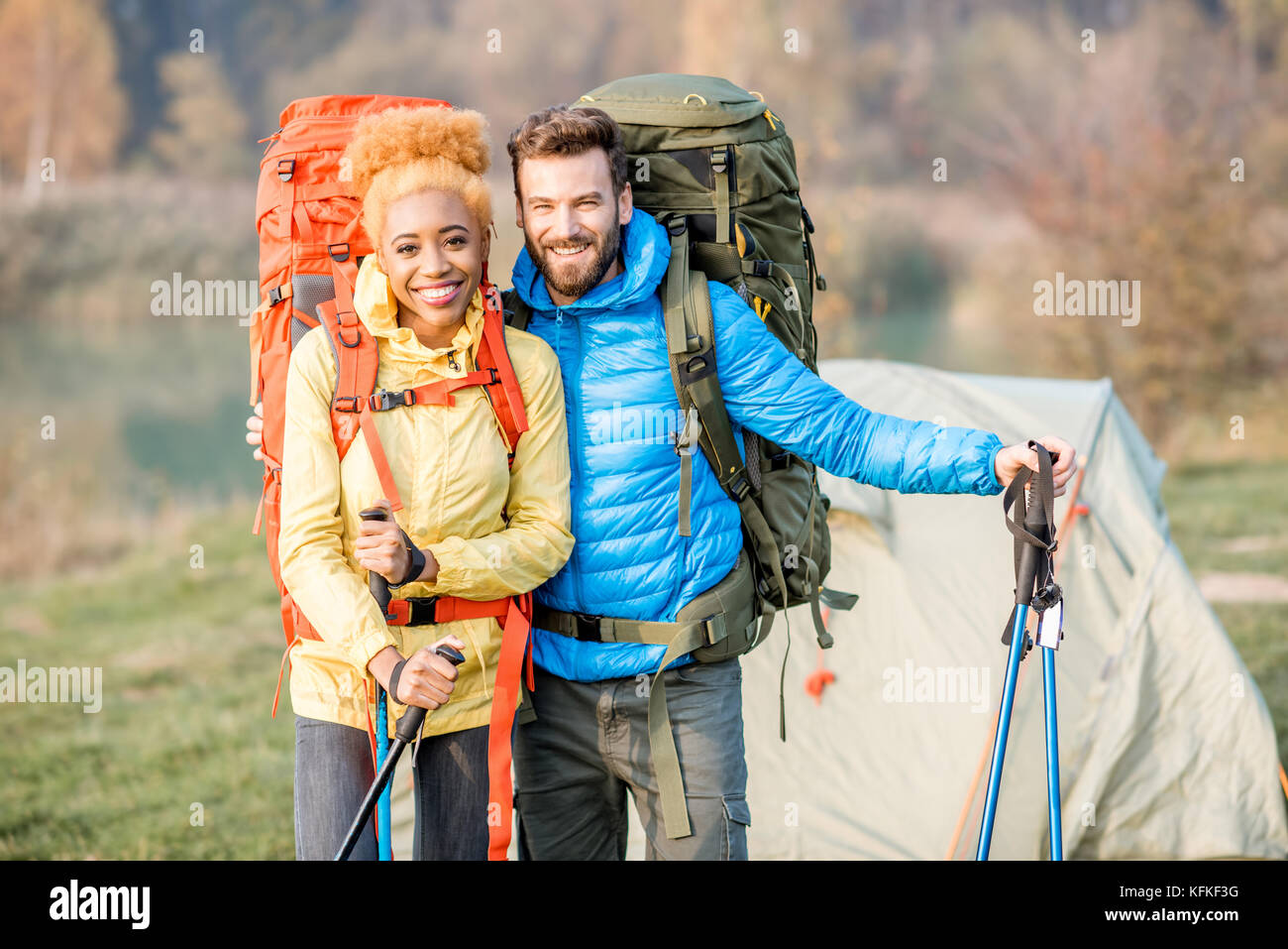 Couple hiking with backpacks Stock Photo - Alamy