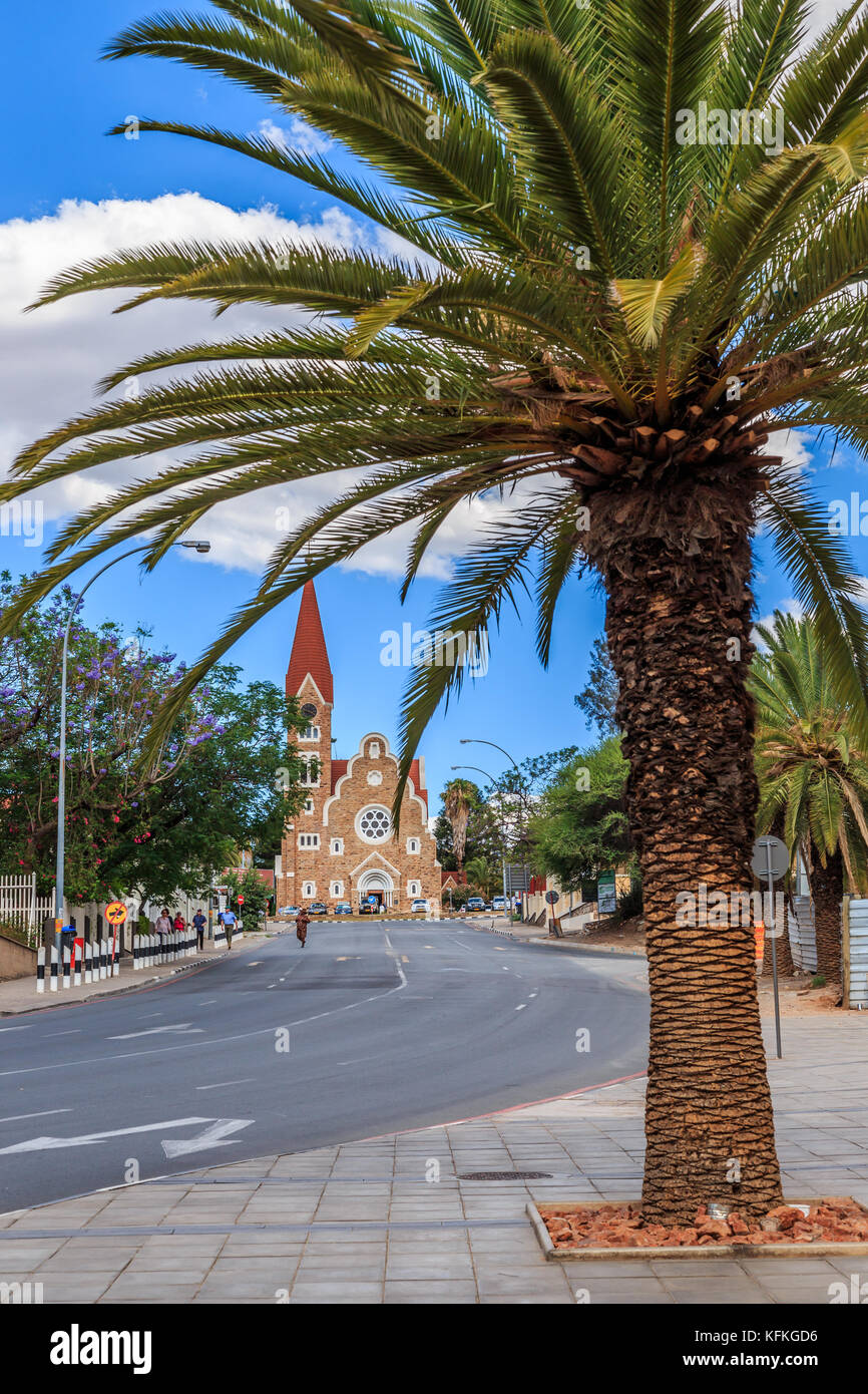 Rows of palm trees and modern building on the central street of ...