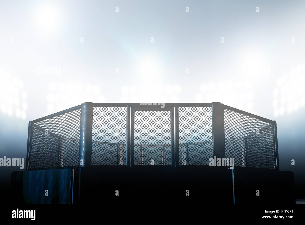 An MMA fight cage arena dressed in black padding lit by arena spot ...