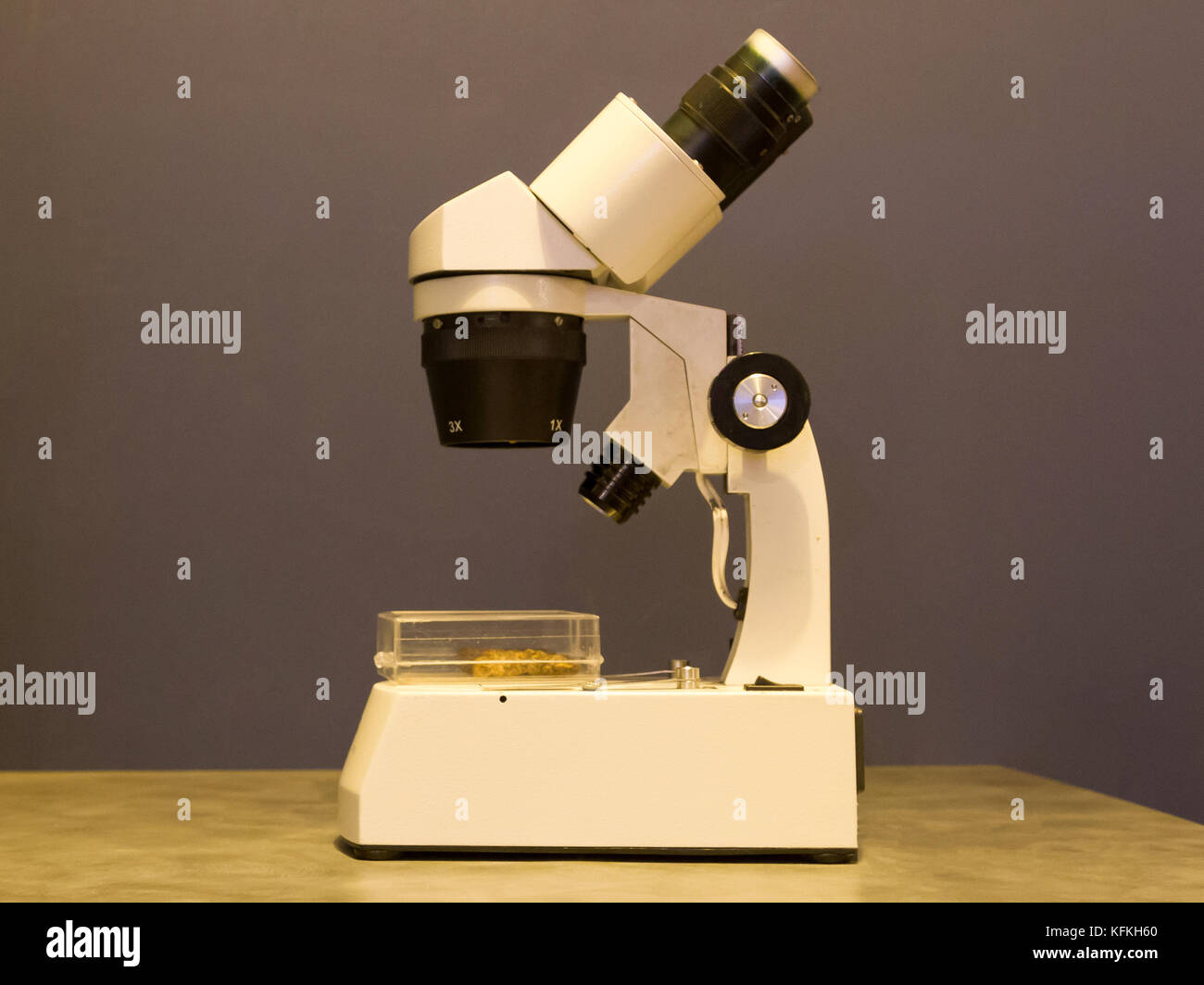 Old simple microscope isolated on a table Stock Photo - Alamy