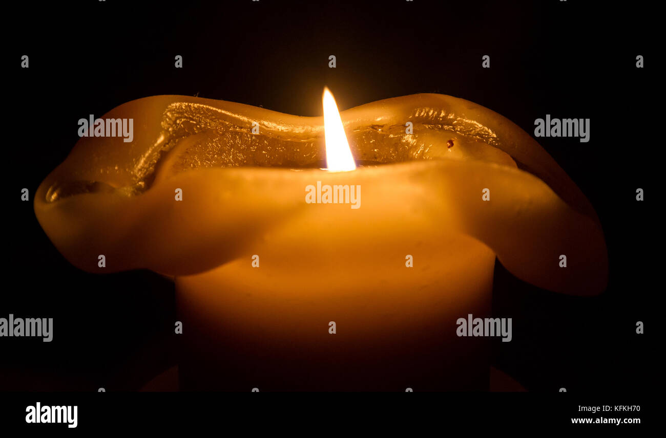 Large candle burning in the darkness, selective focus Stock Photo - Alamy