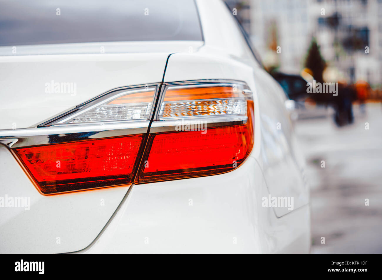Modern blue car tail light in wet rain drop. Red modern car back light ...